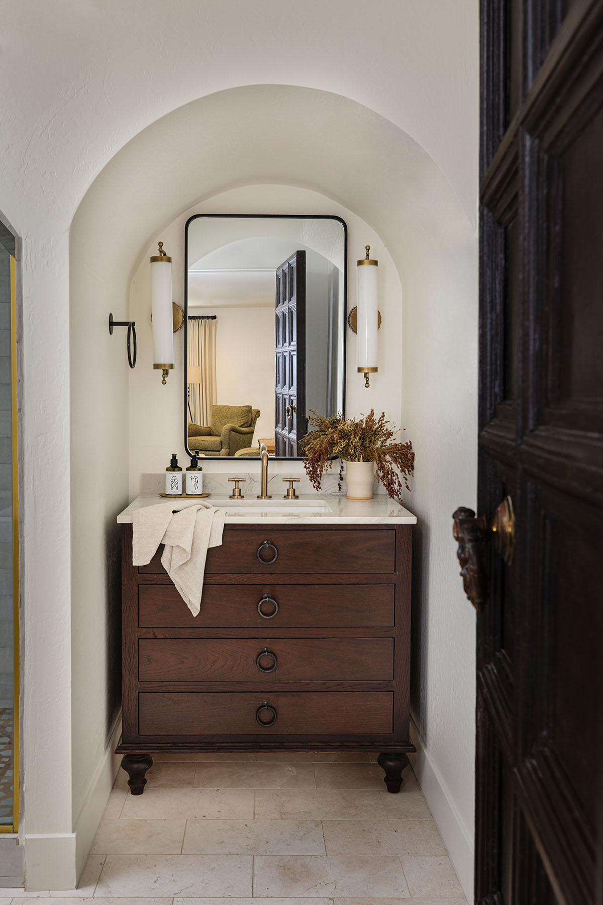Arched vanity nook on both sides of a shower in a Spanish Revival ...